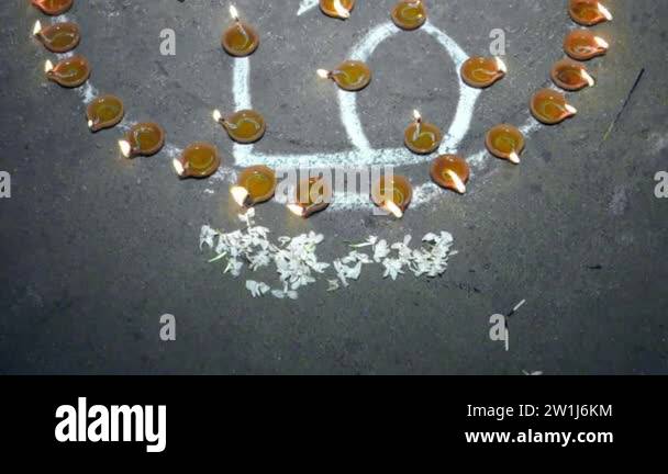 Traditional brass lamp with symbol om inflames, Candle flame close-up ...