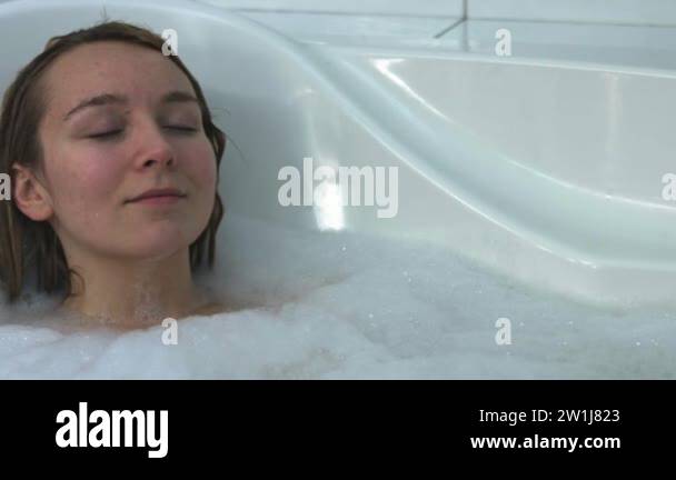 Woman sleeping in bath Stock Video Footage - Alamy