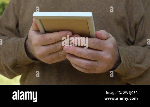 Aged male hugging photo missing children, sad widower remembering wife ...