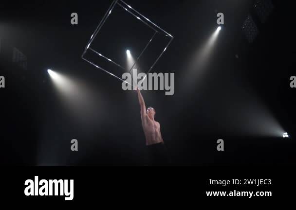 circus male muscular performer making tricks with juggling cube props ...