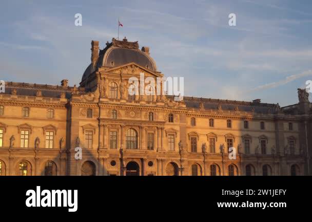 Louvre Museum, was built in 1793. Flag of France waving, on the roof ...