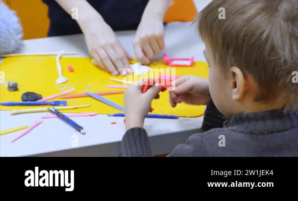 Young Male Child or Boy Artist in an Art Workshop, Sits at a Table and ...