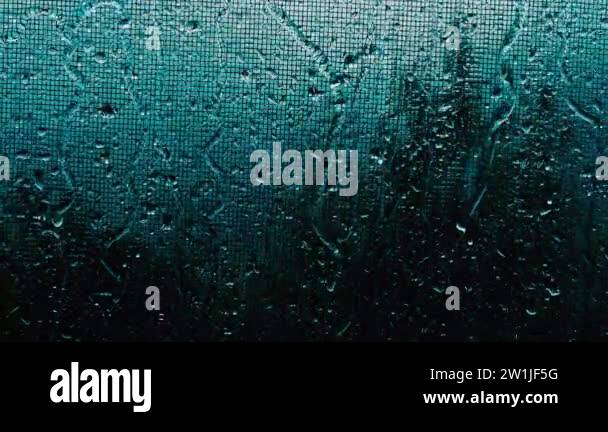 Raindrops flow down the glass,a thunderstorm outside the window ...