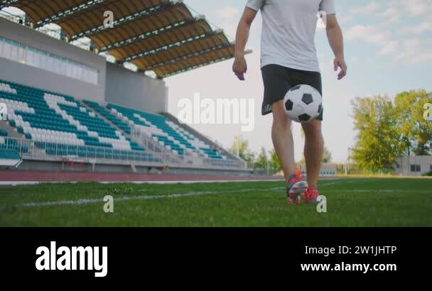 Professional Male soccer player athlete on the football field in slow ...