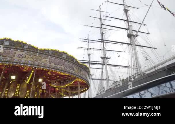 Beautiful carousel on background of large ship. Action. Bright carousel ...