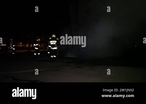 A car is burning and gasoline is dripping and burning. Unrecognizable ...