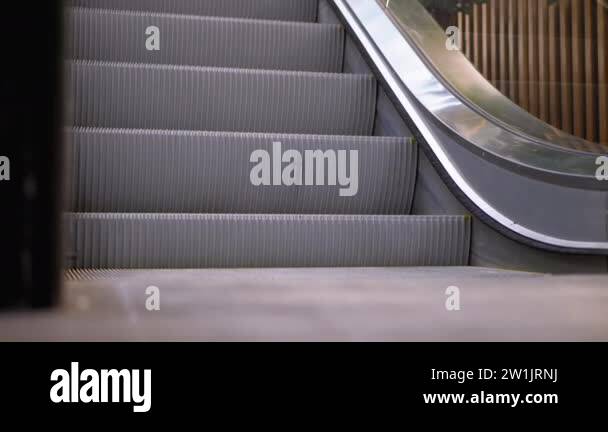 Legs of People Moving on an Escalator Lift in the Mall. Shoppers Feet on Escalator in Shopping ...