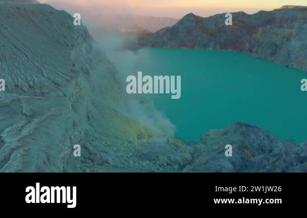 Aerial shot. Sunrise at a famous active Ijen volcano or Kawah Ijen on ...
