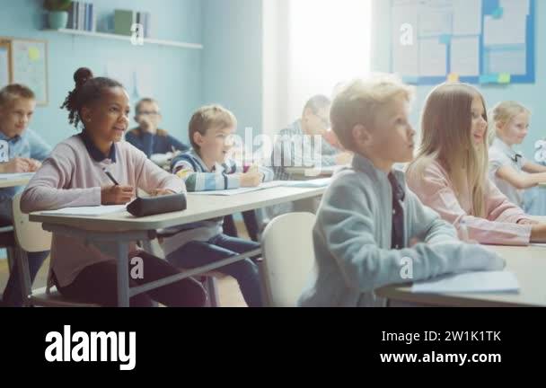 Elementary Classroom of Diverse Bright Children Listening to their ...