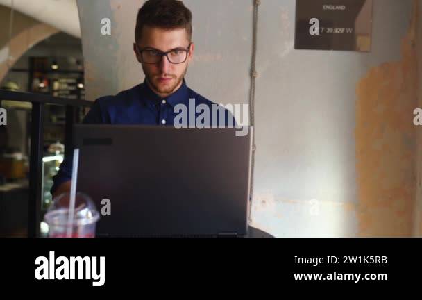 Young freelancer man opens and starts using laptop with biometric face ...