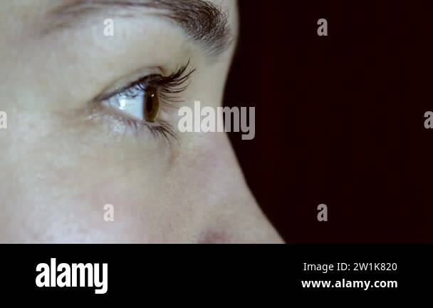 Young beautiful girl opens her green-brown eyes and looks into the ...