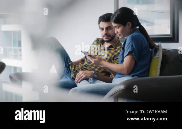 Young couple using cell phone for internet and social media. Happy man ...