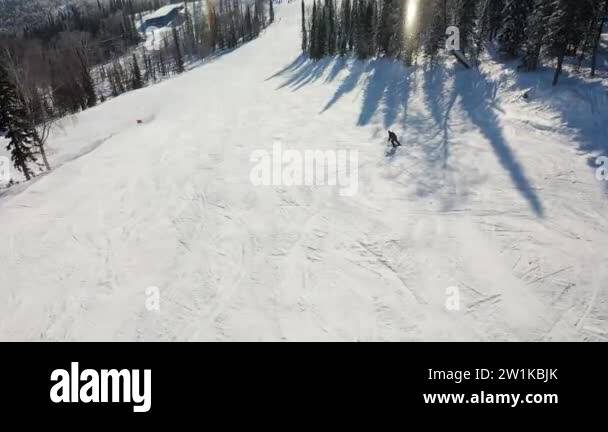 Ski slope. Skiers and snowboarders roll down the track. Aerial ...