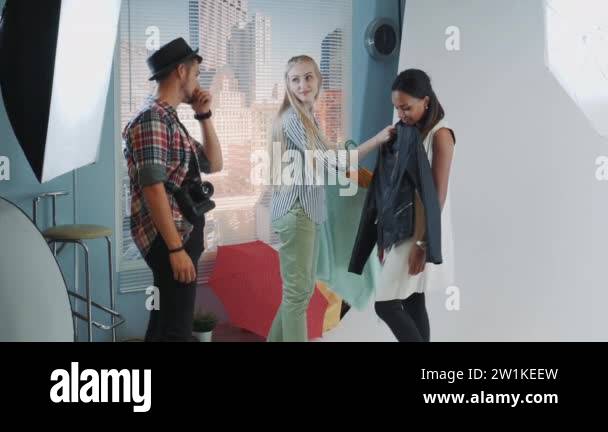 Photo session in modern studio: Stylist and photographer choosing ...