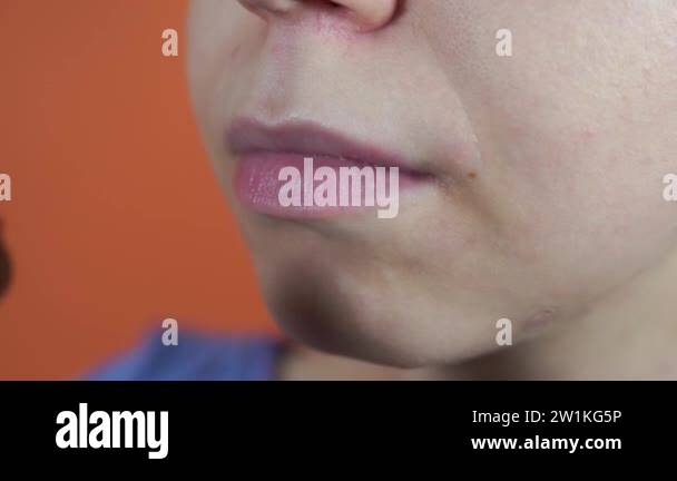 A portrait of the female body part on an orange background. A young ...