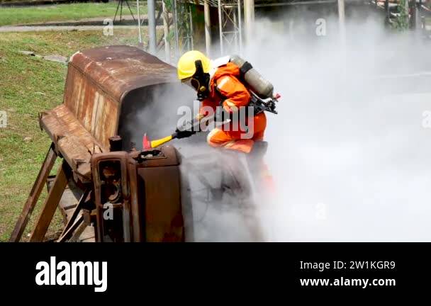 Firefighter fighting with fire flame protection property. Fireman wear ...