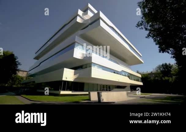 Beautiful white facade of futuristic office building. Action. Facade of ...