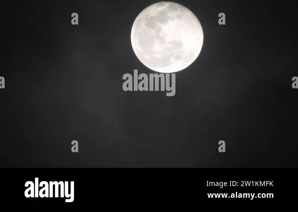 Full moon on dark cloudy night. Clouds passing by the moon, real time ...