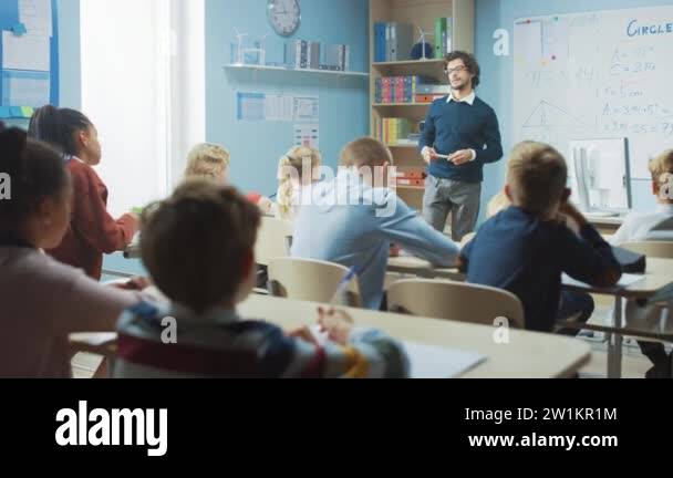 Talented Teacher Explains Lesson to a Classroom Full of Bright Diverse ...