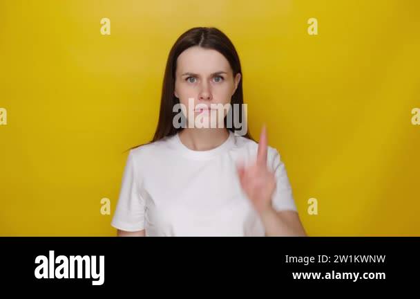 Angry brunette girl pointing finger to camera, looking dissatisfied ...
