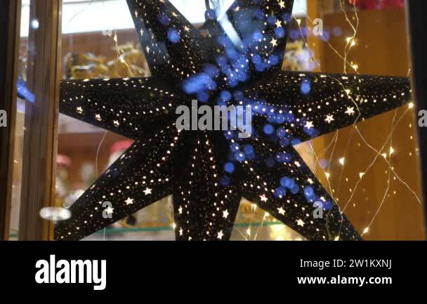 Huge seven corner star in a shop window with New Year's gifts in ...