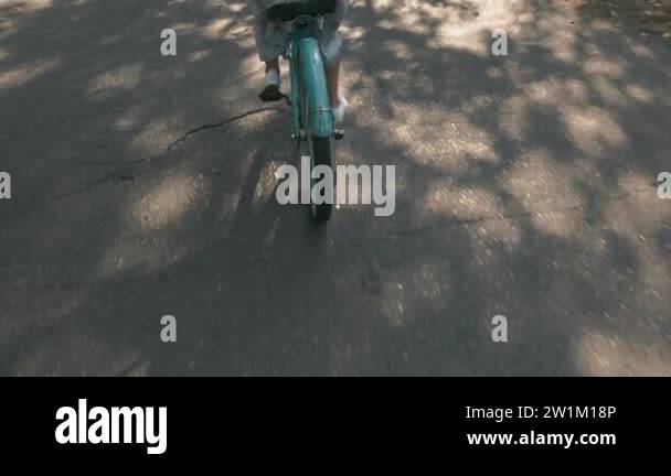 Bike wheels rotation, close up. Female feet is pedaling on vintage ...