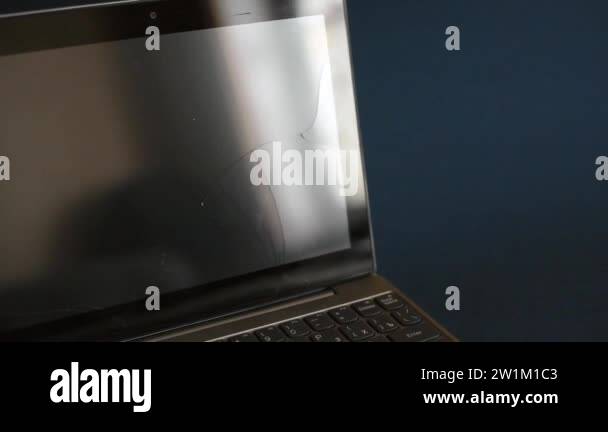 The screen laptop cracked and damaged. A silver laptop with a broken ...