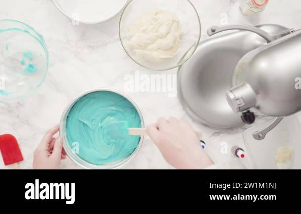 Step by step. Flat lay. Mixing food coloring into the cookie dough to ...