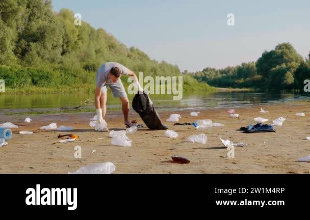 Angry man collects plastic trash on banks of polluted river, then drops ...