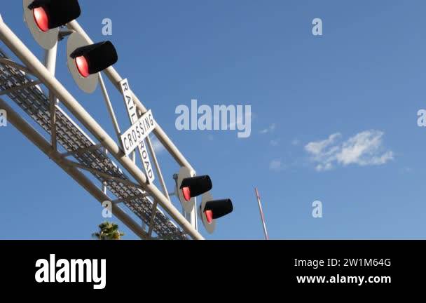Level crossing warning signal in USA. Crossbuck notice and red traffic ...