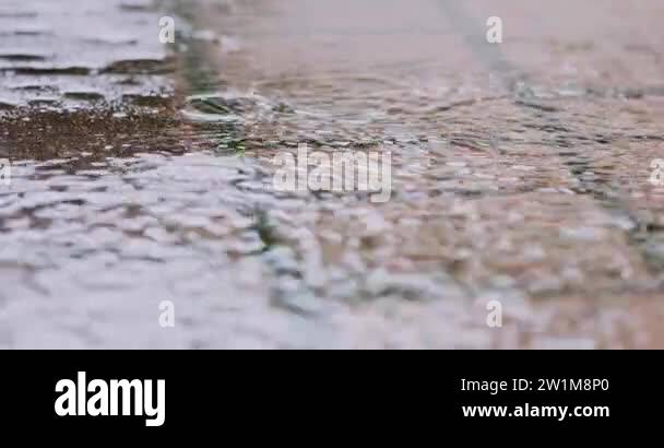 SLOW MOTION CLOSE UP 4K: rain water drops falling into big puddle on ...