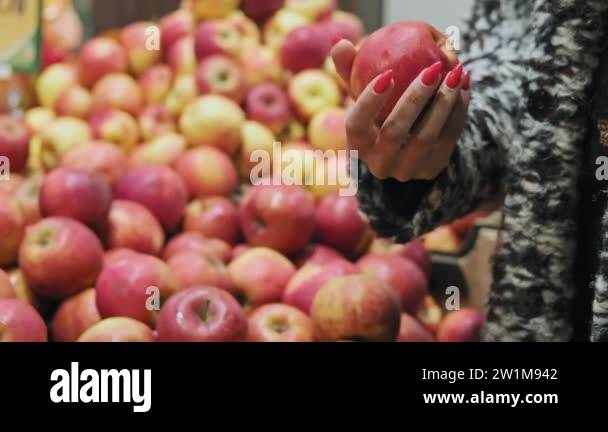 Woman buying apples in supermarket. Close-up of african american female ...