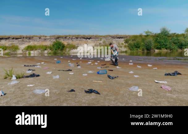 Angry man collects plastic trash on banks of polluted river, then drops ...