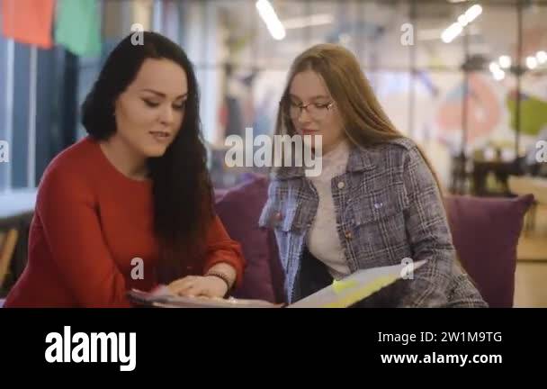 The girl helps a classmate understand the lecture, do homework. Girls ...