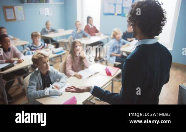 Elementary Classroom of Diverse Bright Children Listening to the ...