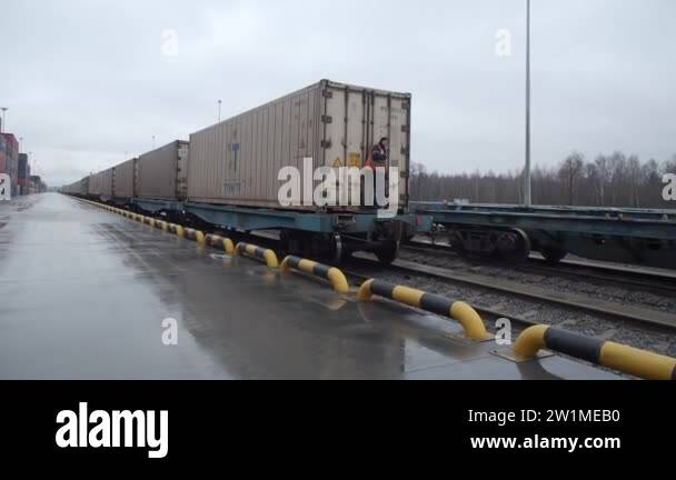 Transportation of cargoes by rail in containers.Arrival of freight train at the railway station ...
