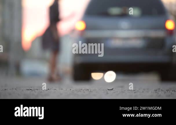 Woman driver putting an emergency stop sign behind broken blurred car ...