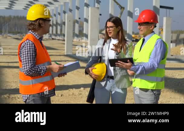 Architect, Foreman and Construction Worker Having Conversation at Building Site. Business ...