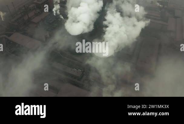 Epic aerial of high pipes with smoke emission. Plant pipes pollute ...