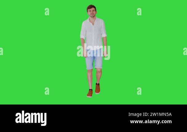 Casual young man walking and looking forward on a Green Screen, Chroma ...