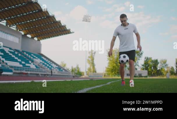 Professional Male soccer player athlete on the football field in slow ...