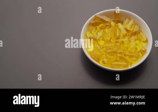 Omega 3 gold fish oil capsules are dropping. Capsule gold oil gel ...