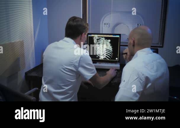 In Control Room Doctor and Radiologist Discuss Diagnosis while Watching ...
