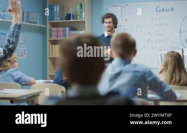 Teacher Explains Lesson to a Diverse Classroom of Bright Children, Asks ...