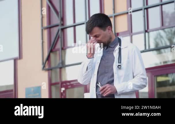 Topic is overtime work, heavy workload of medical workers. Young tired ...