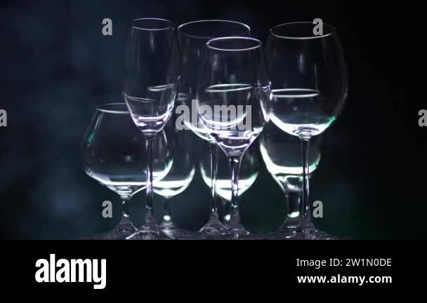 Empty glasses slowly rotating on the bar counter at the night club ...