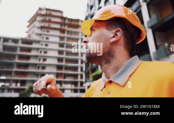 Construction site manager with expression of angry in orange uniform ...