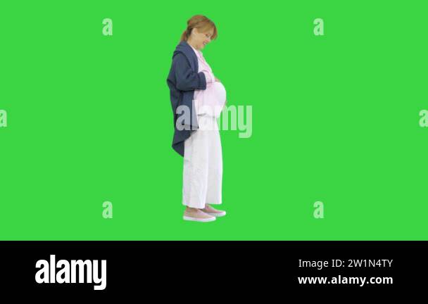 Pregnant woman caressing her belly on a Green Screen, Chroma Key Stock ...