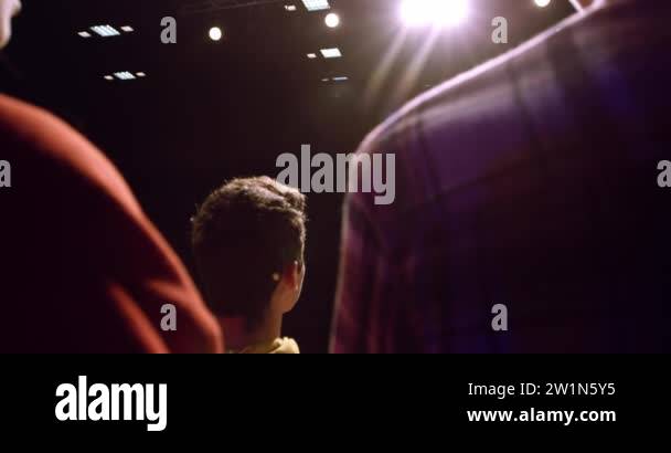 Over the shoulder view of a Caucasian female conductor directing a ...