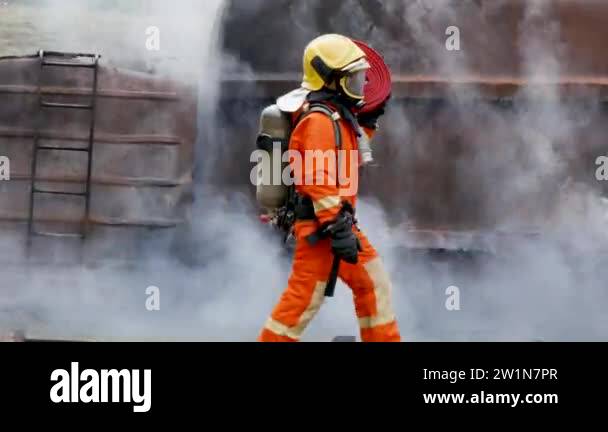 Firefighter fighting with fire flame protection property. Fireman wear ...